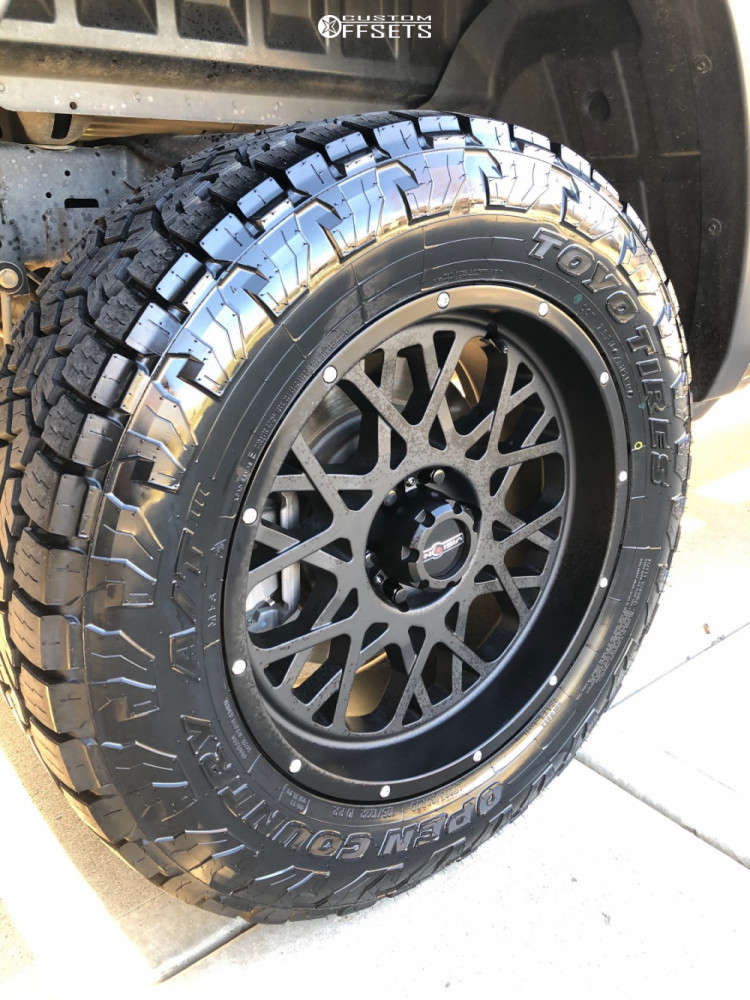 2020 Ram 1500 with 20x10 -24 Vision Rocker and 33/12.5R20 Nitto Open ...