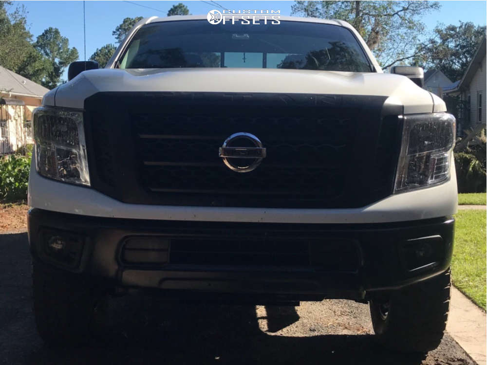 2017 Nissan Titan XD with 18x9 -12 Vision Rocker and 295/65R18 Pro Comp ...